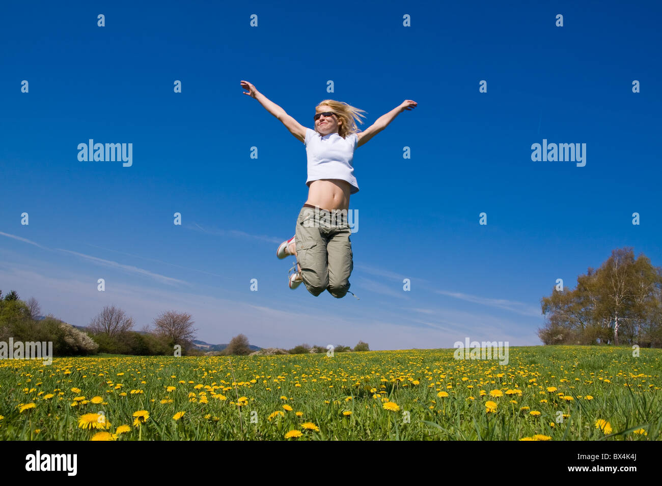 young female having fun on flowery meadow Stock Photo - Alamy