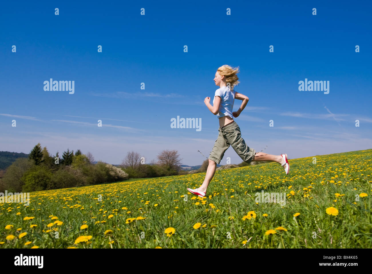 young female having fun on flowery meadow Stock Photo - Alamy
