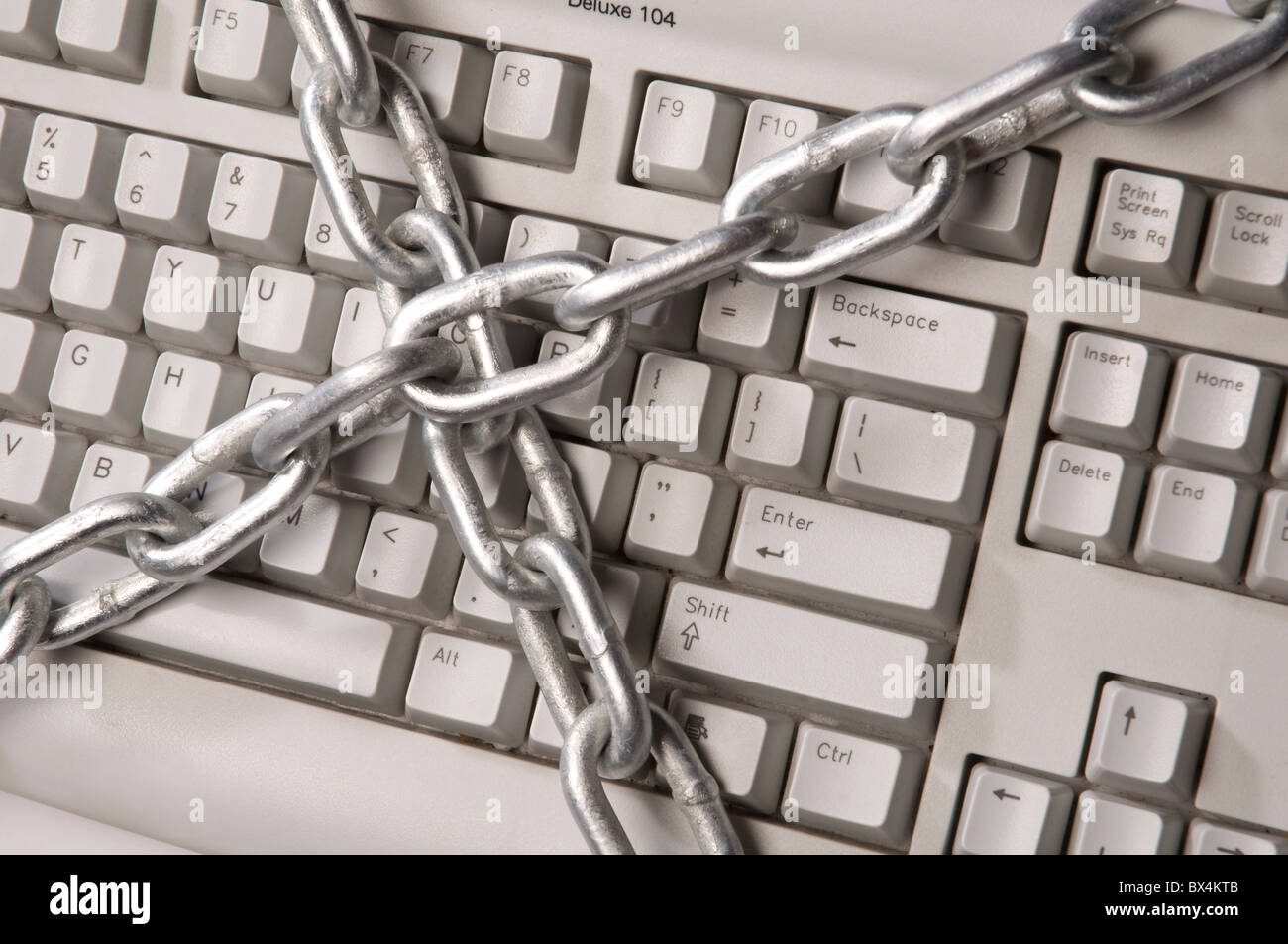 Metal chain securing computer keyboard Stock Photo - Alamy