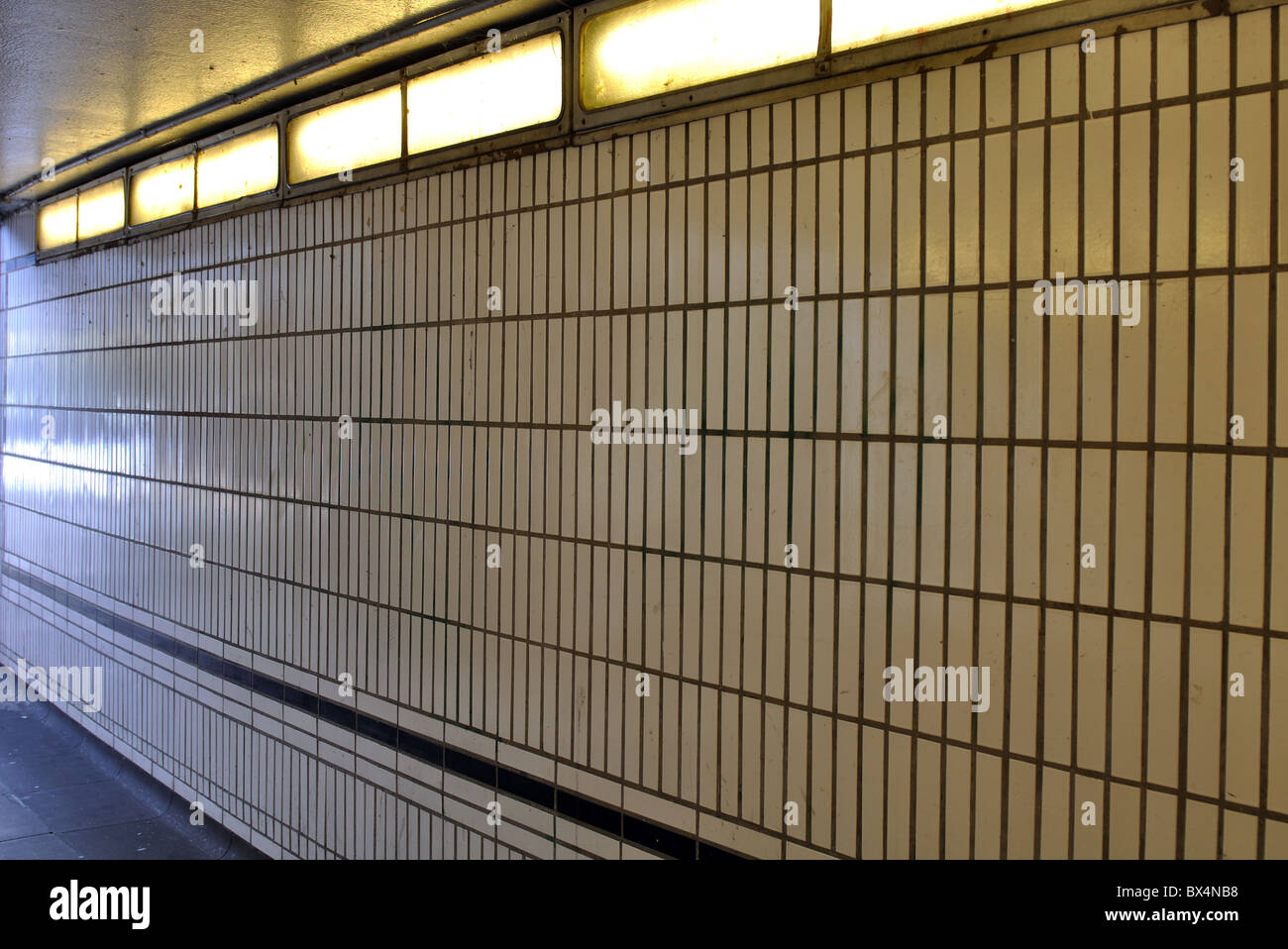 White tiled wall of pedestrian underpass, Coventry city centre, UK ...