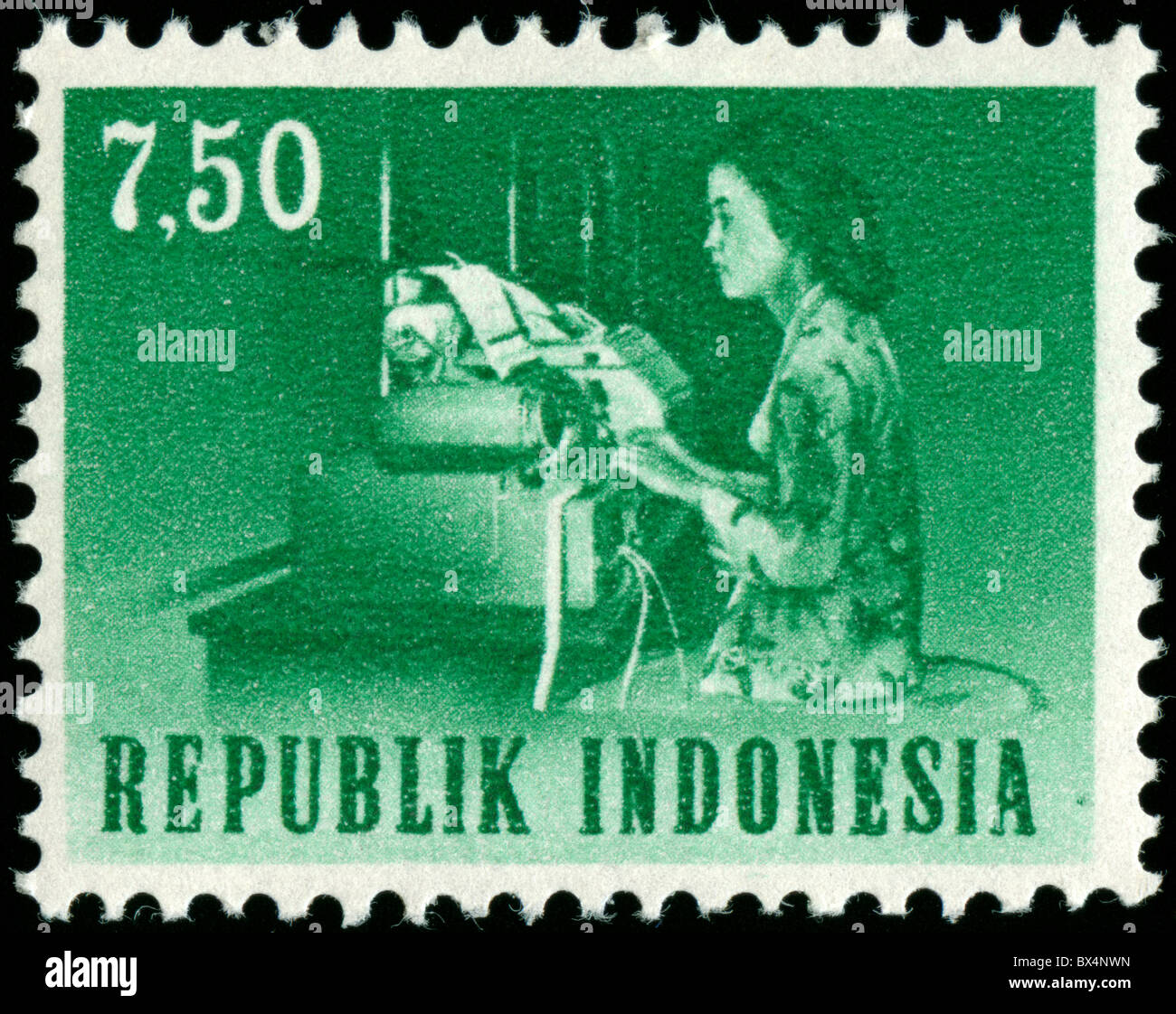 Postage stamp from Indonesia with image of a woman working Stock Photo ...
