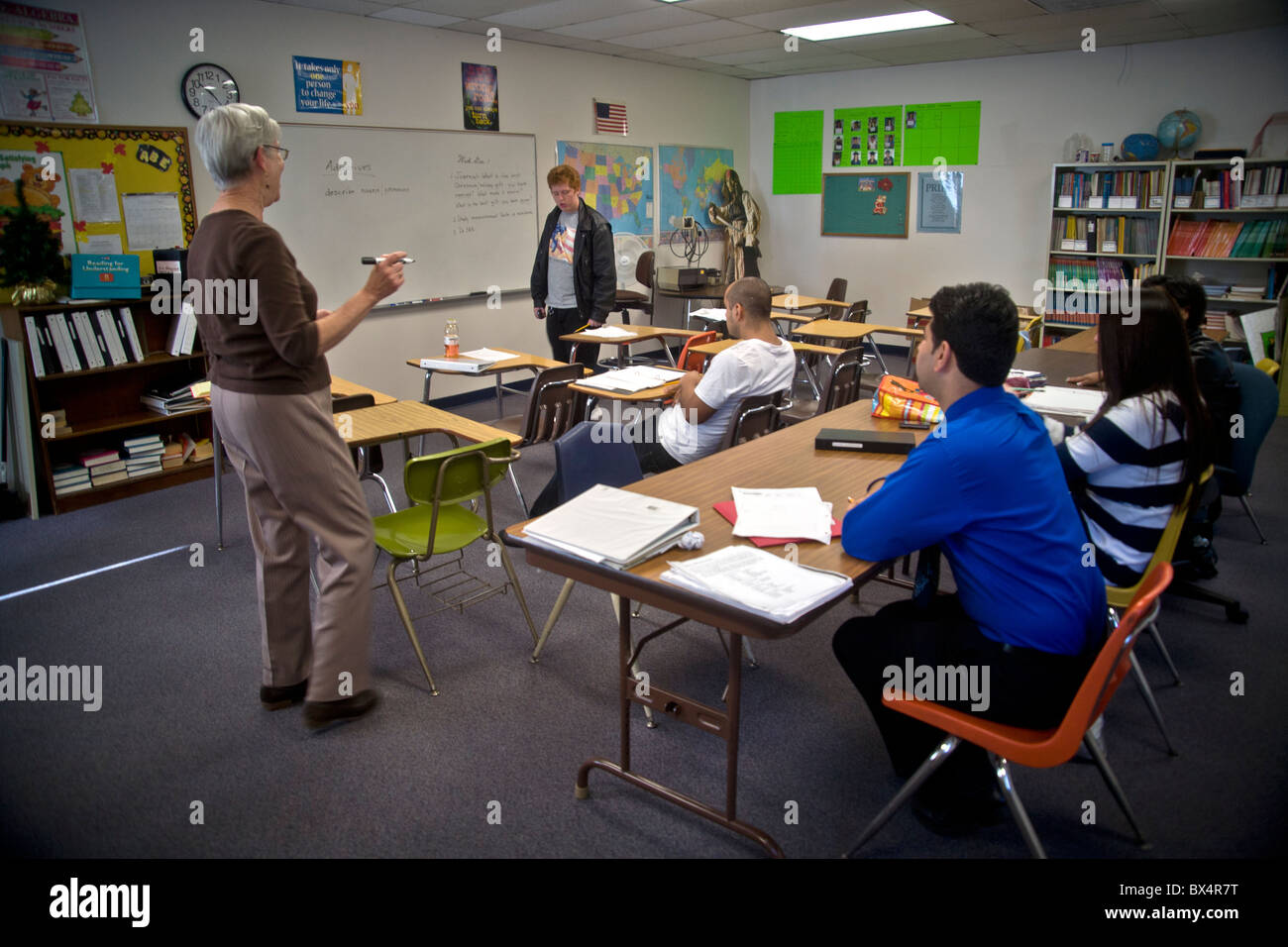 A teacher greets her student in a community adult basic literacy class ...