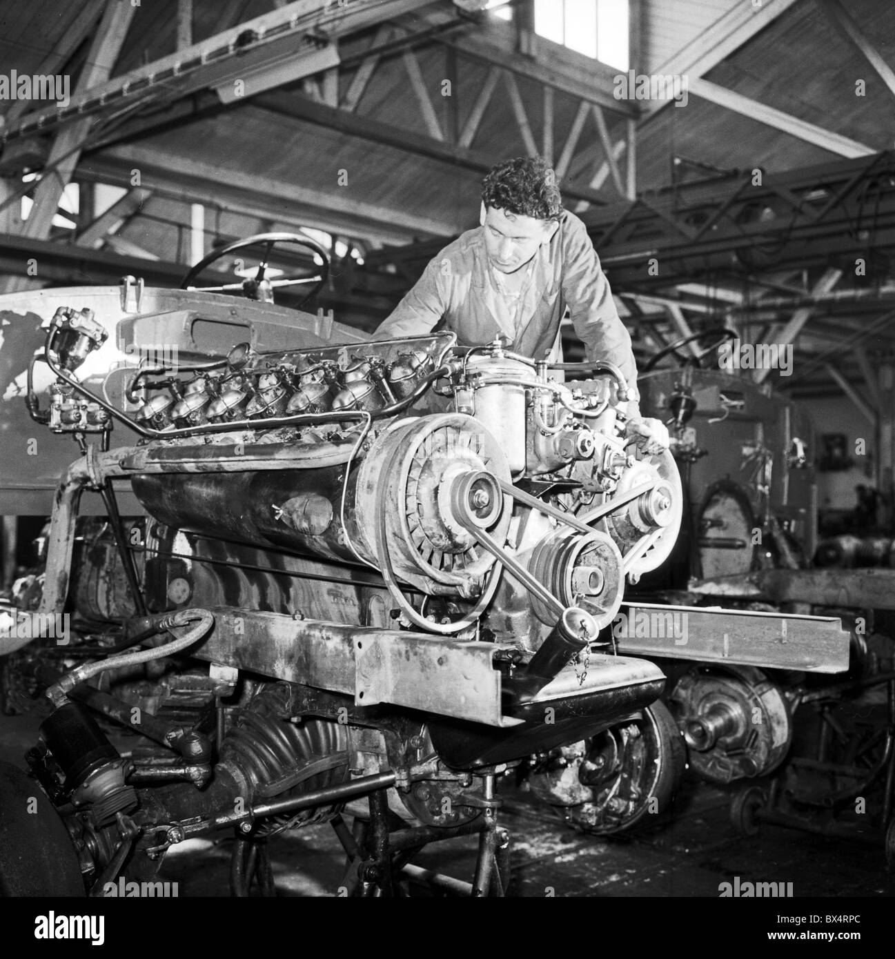 Truck engine is being repaired by mechanic. Slany, Czechoslovakia 1963 ...