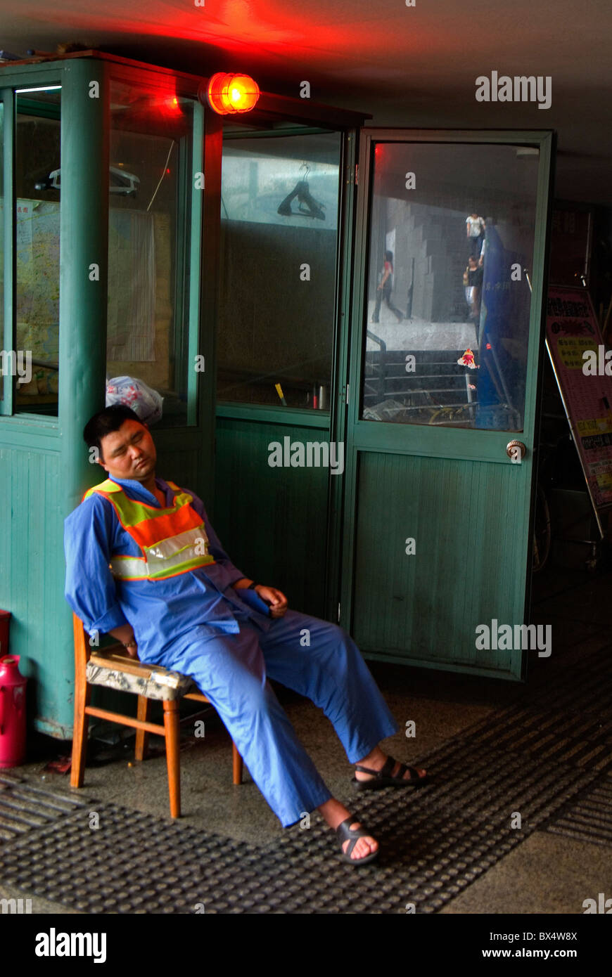 Shanghai - subway security guard sleeping under flashing warning light ...