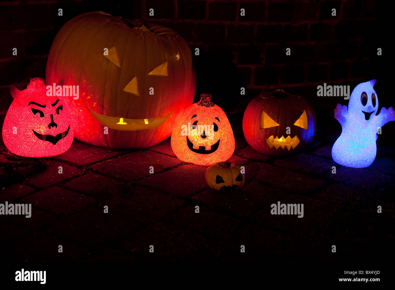 Halloween pumpkins, ghouls and ghosts all ganged up together on a dark ...