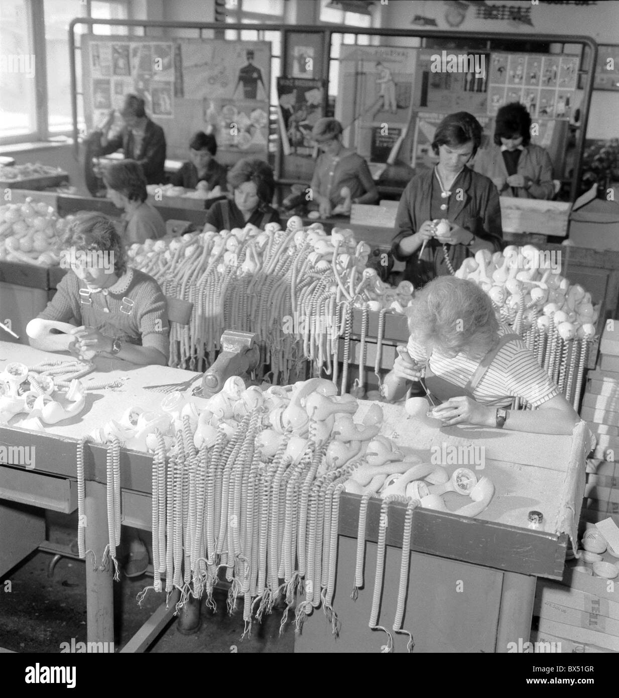 Female employees of Tesla telephone maker assemble receivers at ...