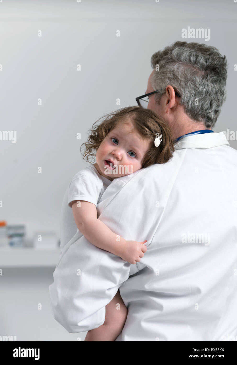 Doctor holding baby back view hi-res stock photography and images - Alamy