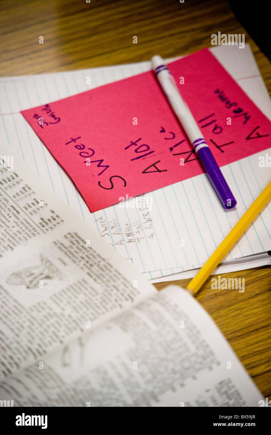 A red adjective card is supplied by the teacher in a community adult ...