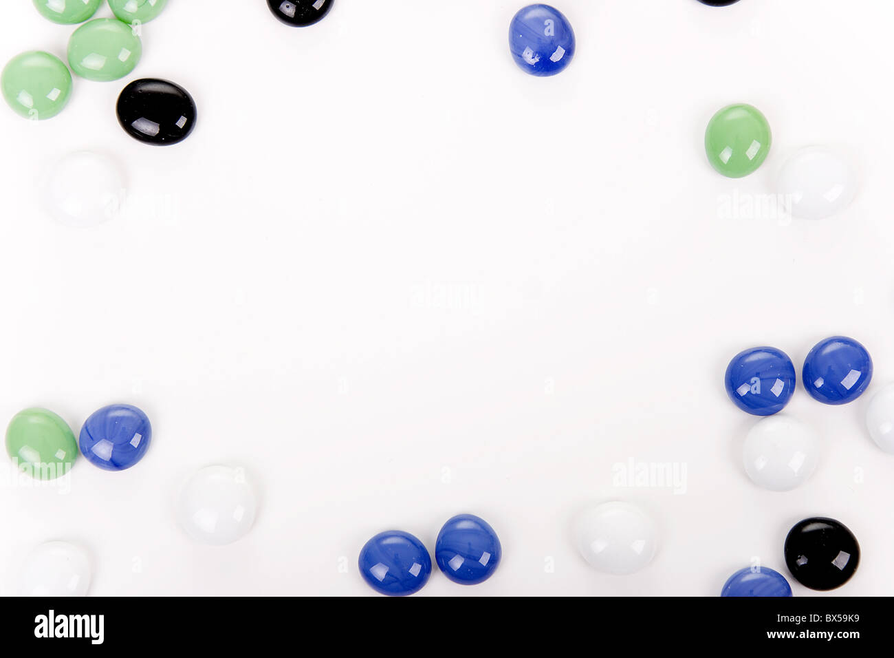 Colour round smooth stones on white table Stock Photo - Alamy