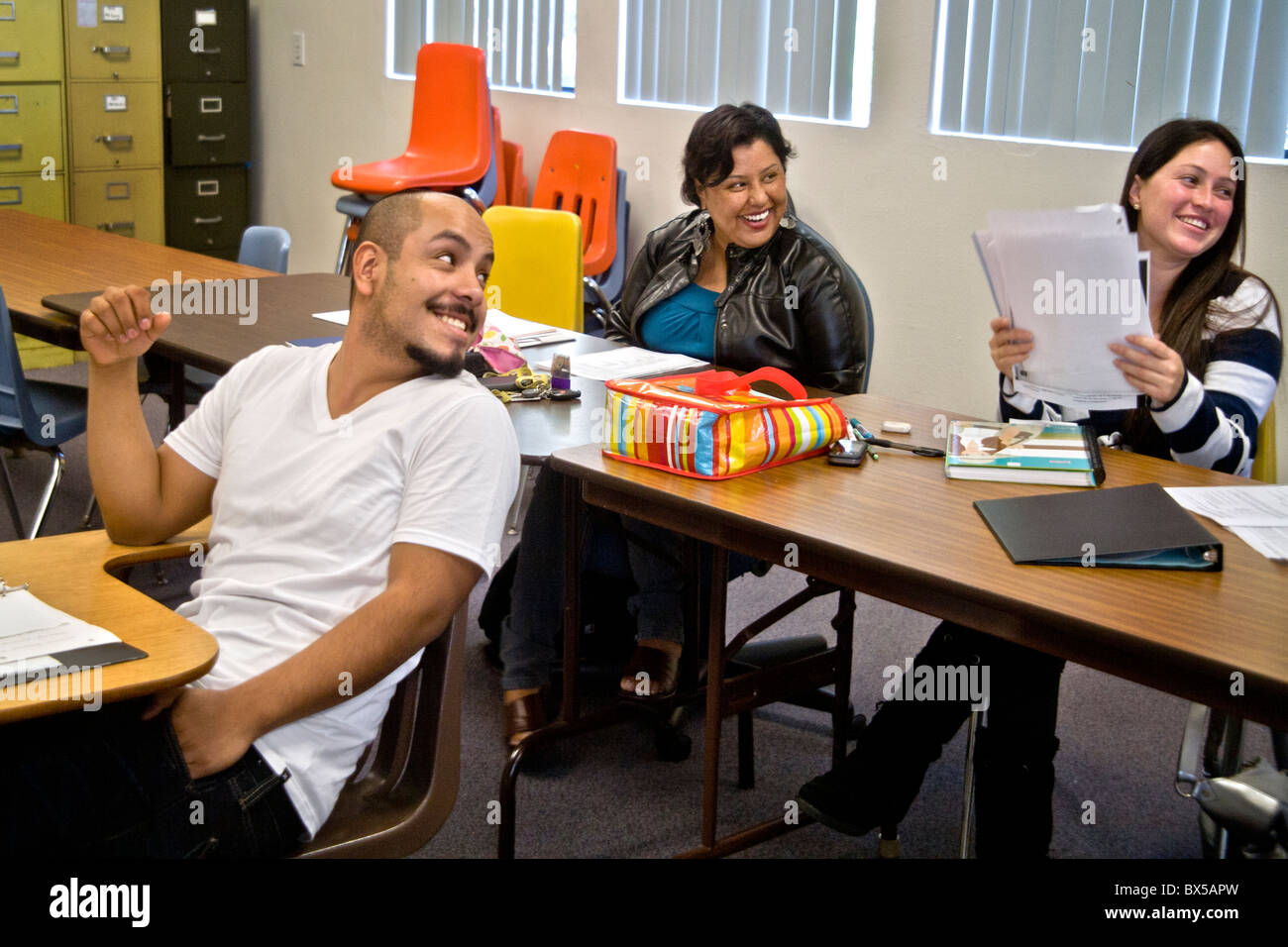 Hispanic young adults support each other in a community adult basic ...