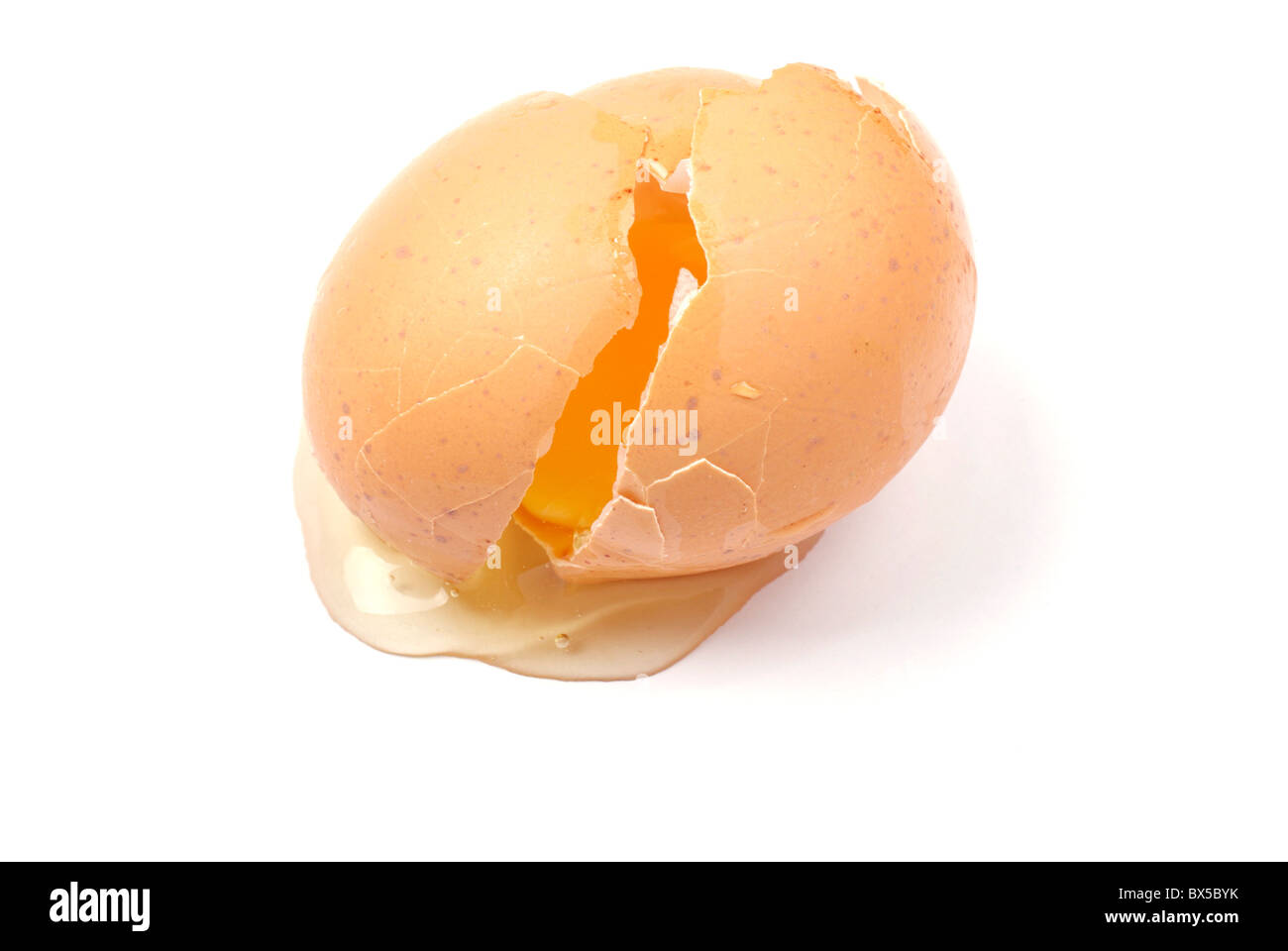 Damaged brown egg isolated on white background Stock Photo - Alamy