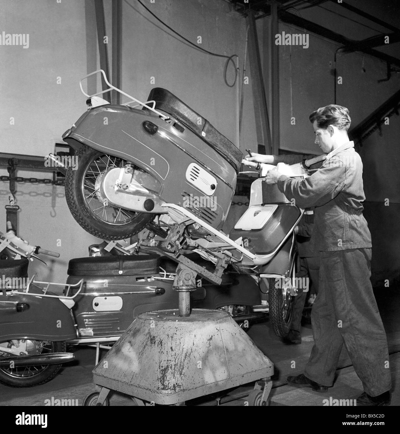 Factory worker assembles scooter "Manet" in Klement Gottwlad plant ...