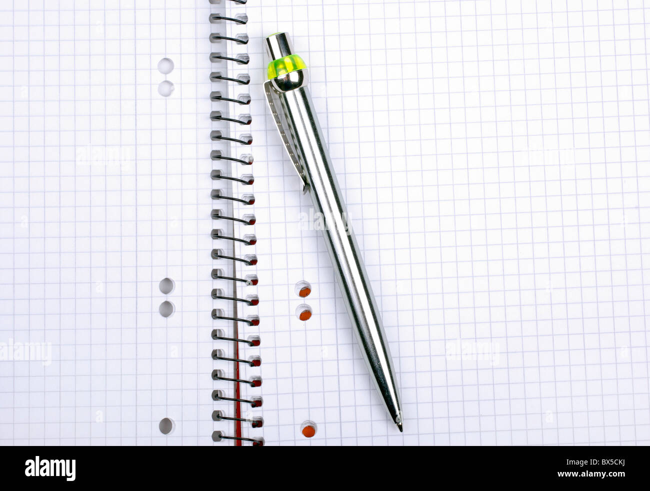 Ballpoint metallic pen laying on spiral notebook Stock Photo - Alamy