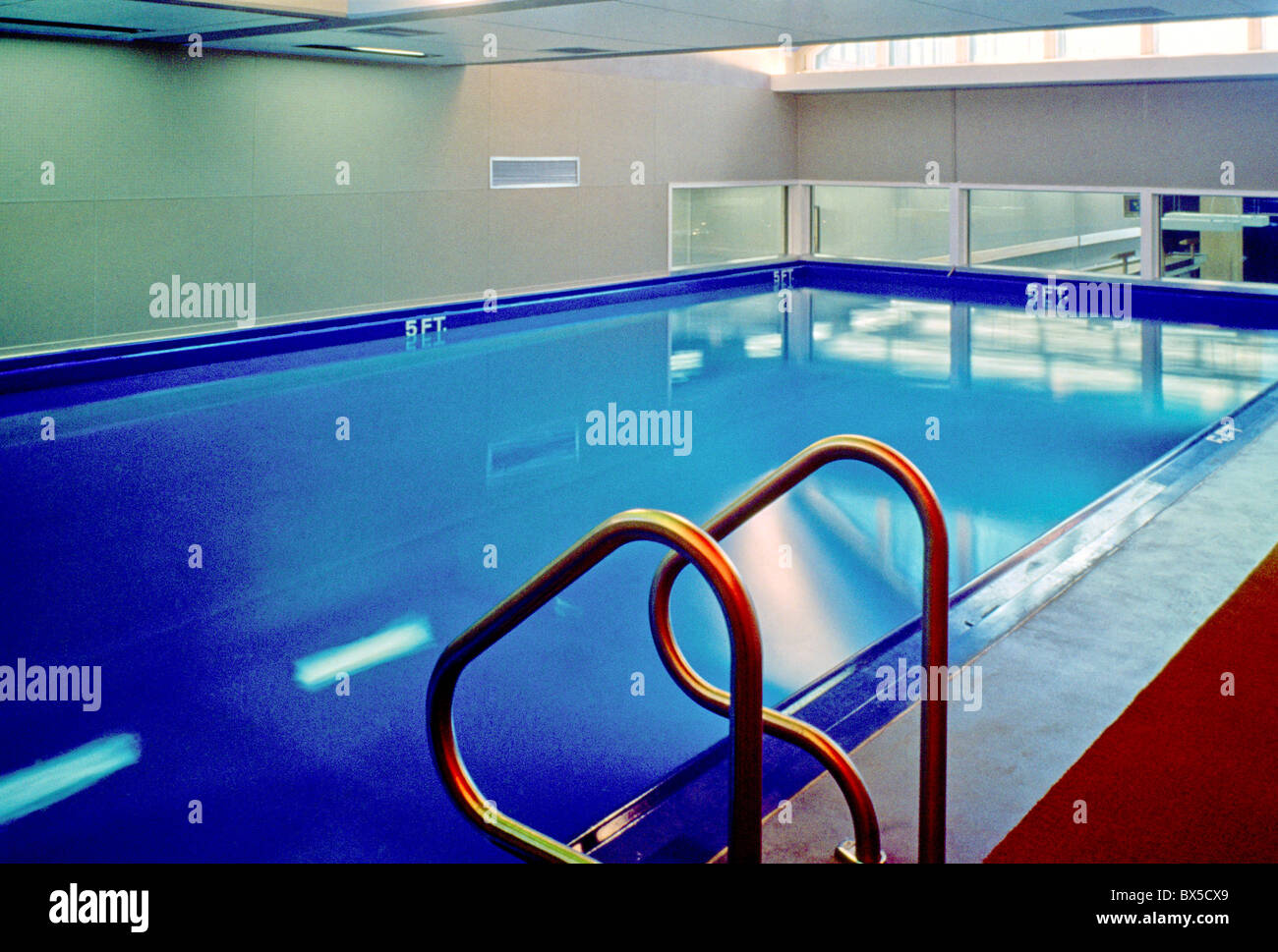 An indoor dormitory swimming pool has depths indicated by poolside ...