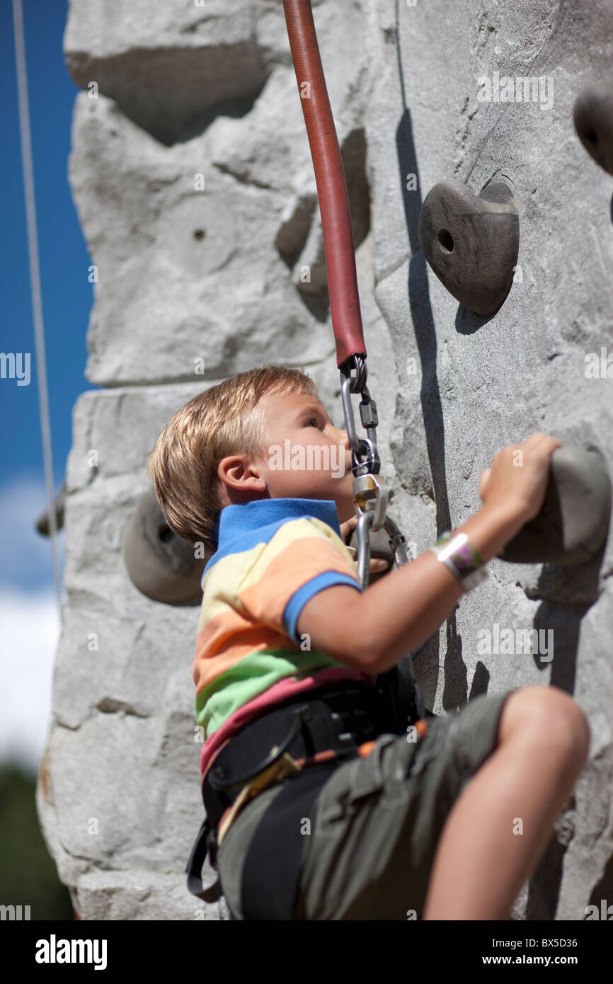 Boy on climbing wall in mountains Stock Photo - Alamy
