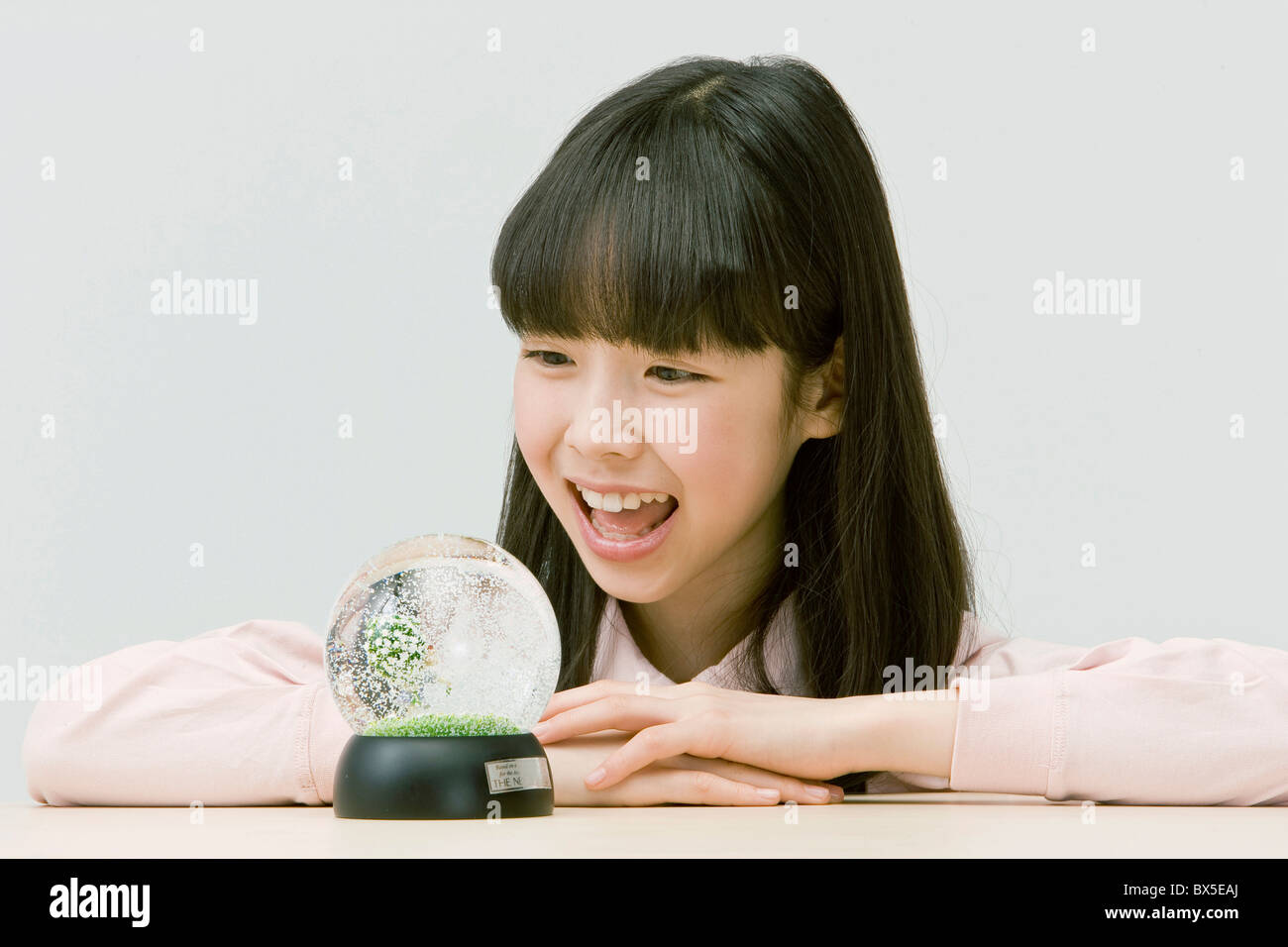 Girl looking at snowball, close-up Stock Photo - Alamy