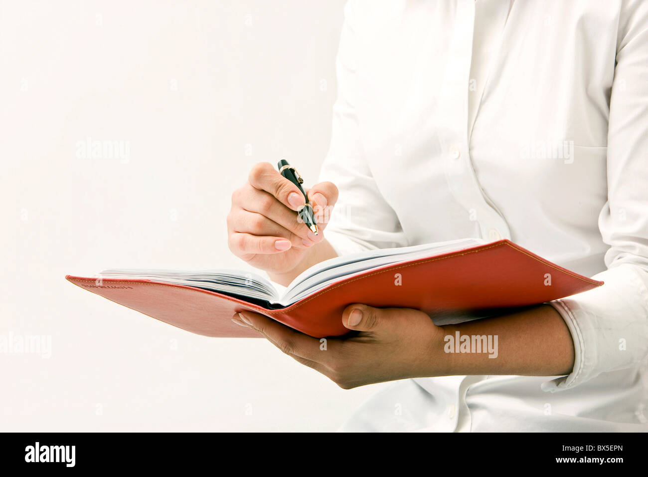 Woman writing on note, close-up Stock Photo - Alamy