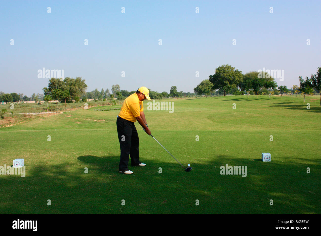 A golfer making a driver shot Stock Photo - Alamy