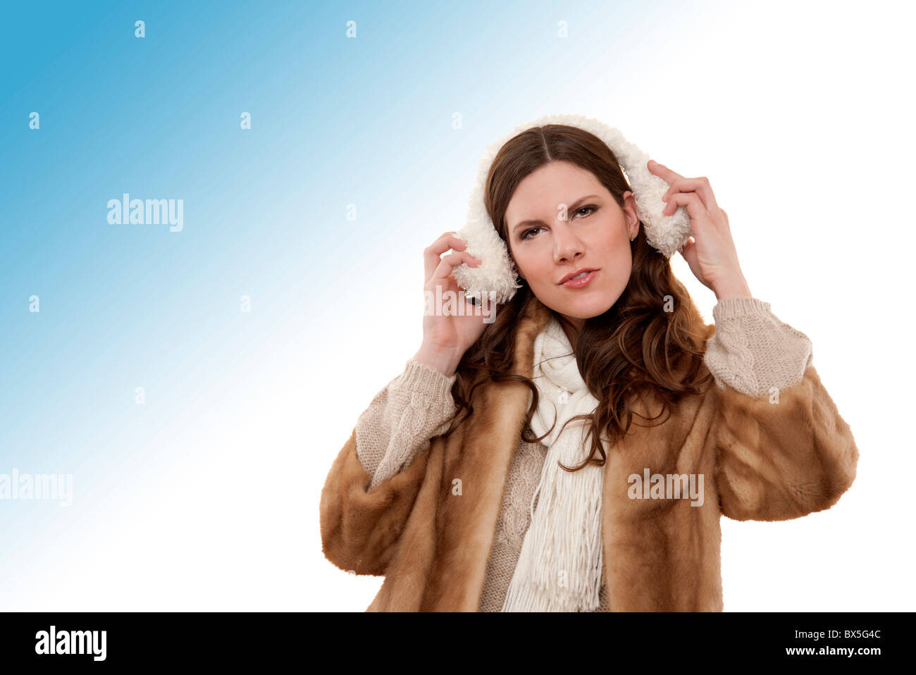 woman wearing a fur coat and ear muffs winter Stock Photo - Alamy