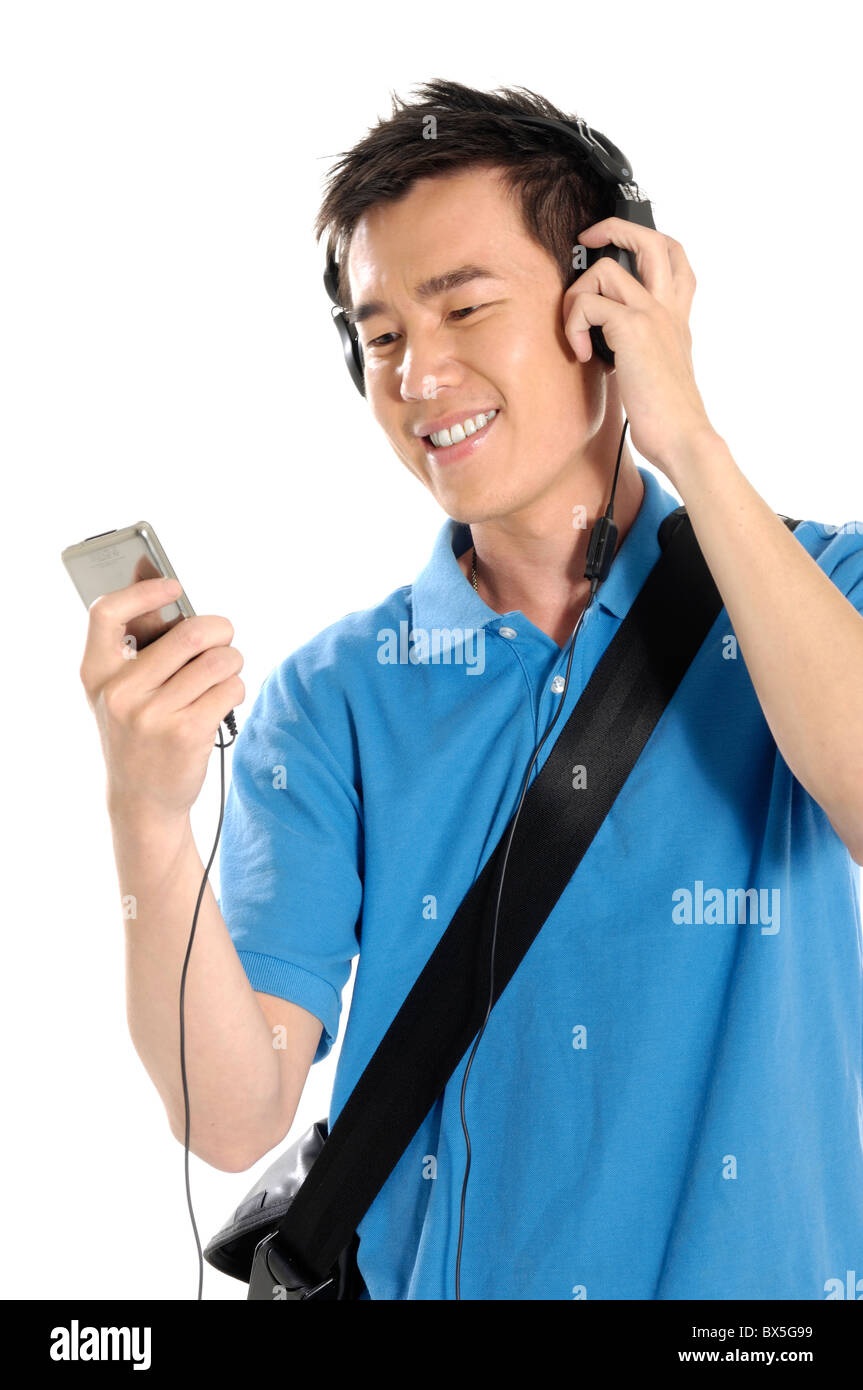 Male university student listening to an mp3 player Stock Photo - Alamy