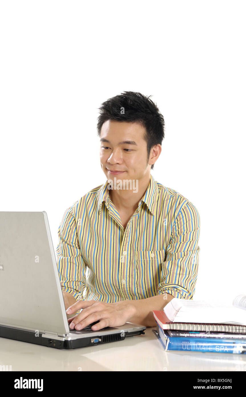 Male university student using a laptop Stock Photo - Alamy