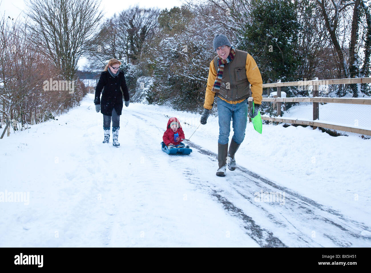 Young boy being pulled on a sledge in the snow , Hattingley , Hampshire ...