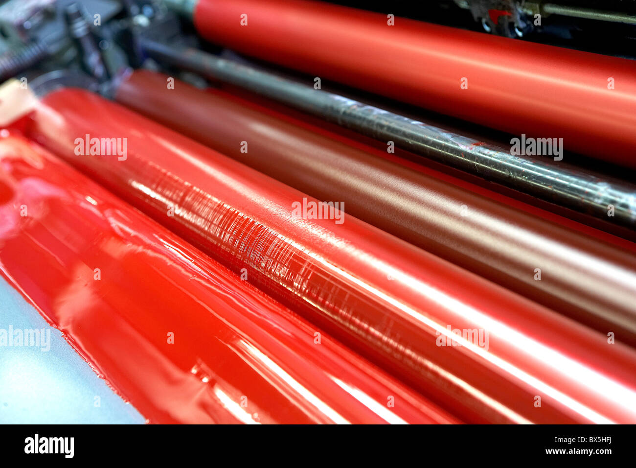 Commercial printer with red dye and rollers Stock Photo - Alamy