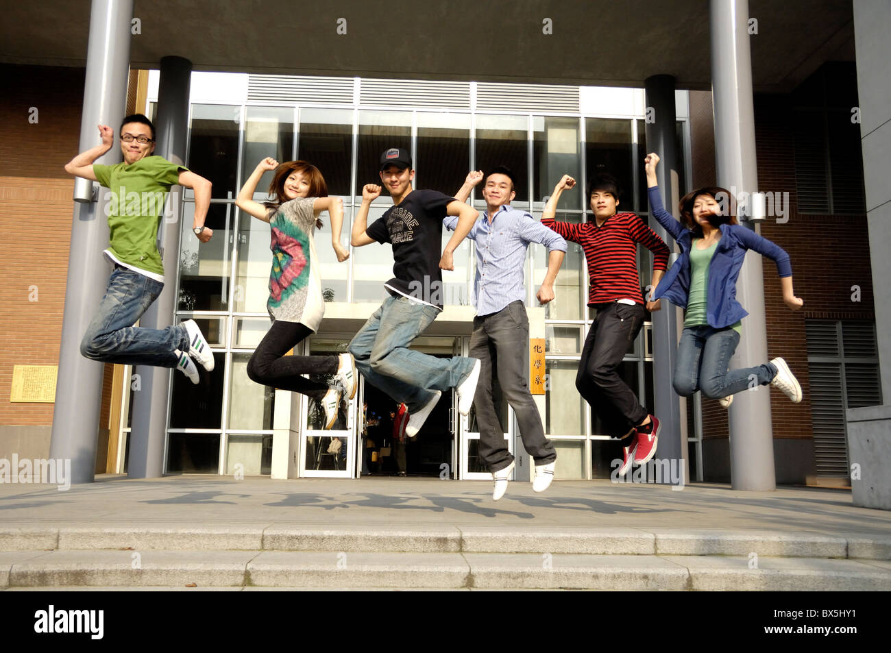 University students jumping together Stock Photo - Alamy