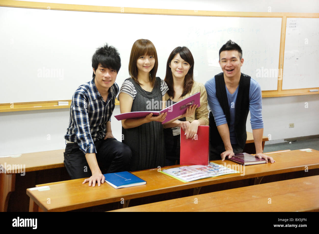 University students smiling in a classroom Stock Photo - Alamy