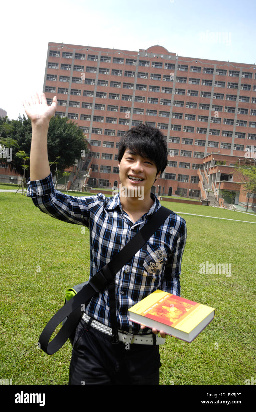 Male university student waving his hand and smiling Stock Photo - Alamy