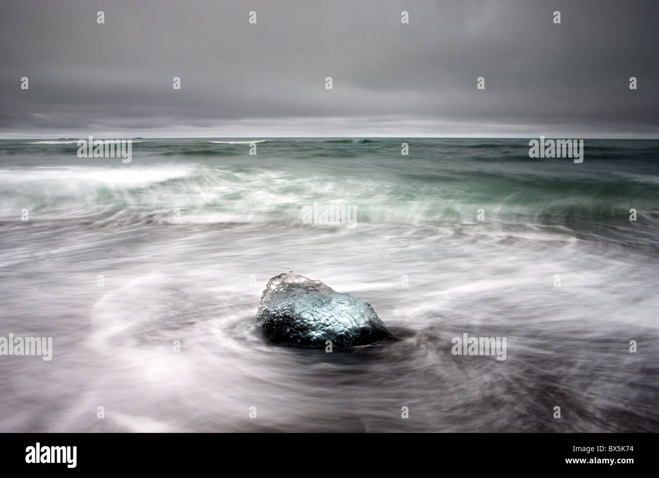 Piece of glacial ice washed ashore by the incoming tide near glacial ...
