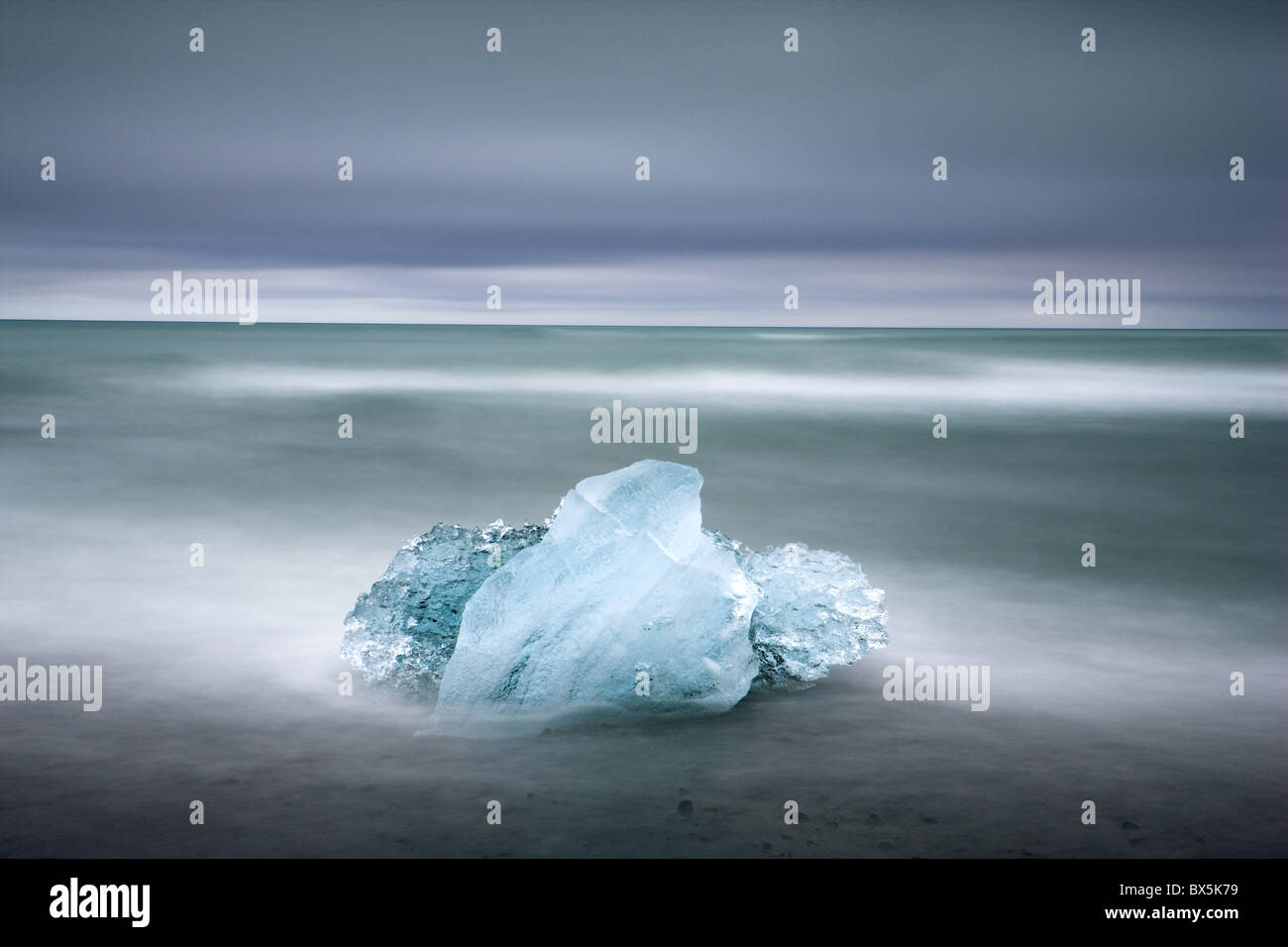 Piece of glacial ice washed ashore by the incoming tide near glacial ...
