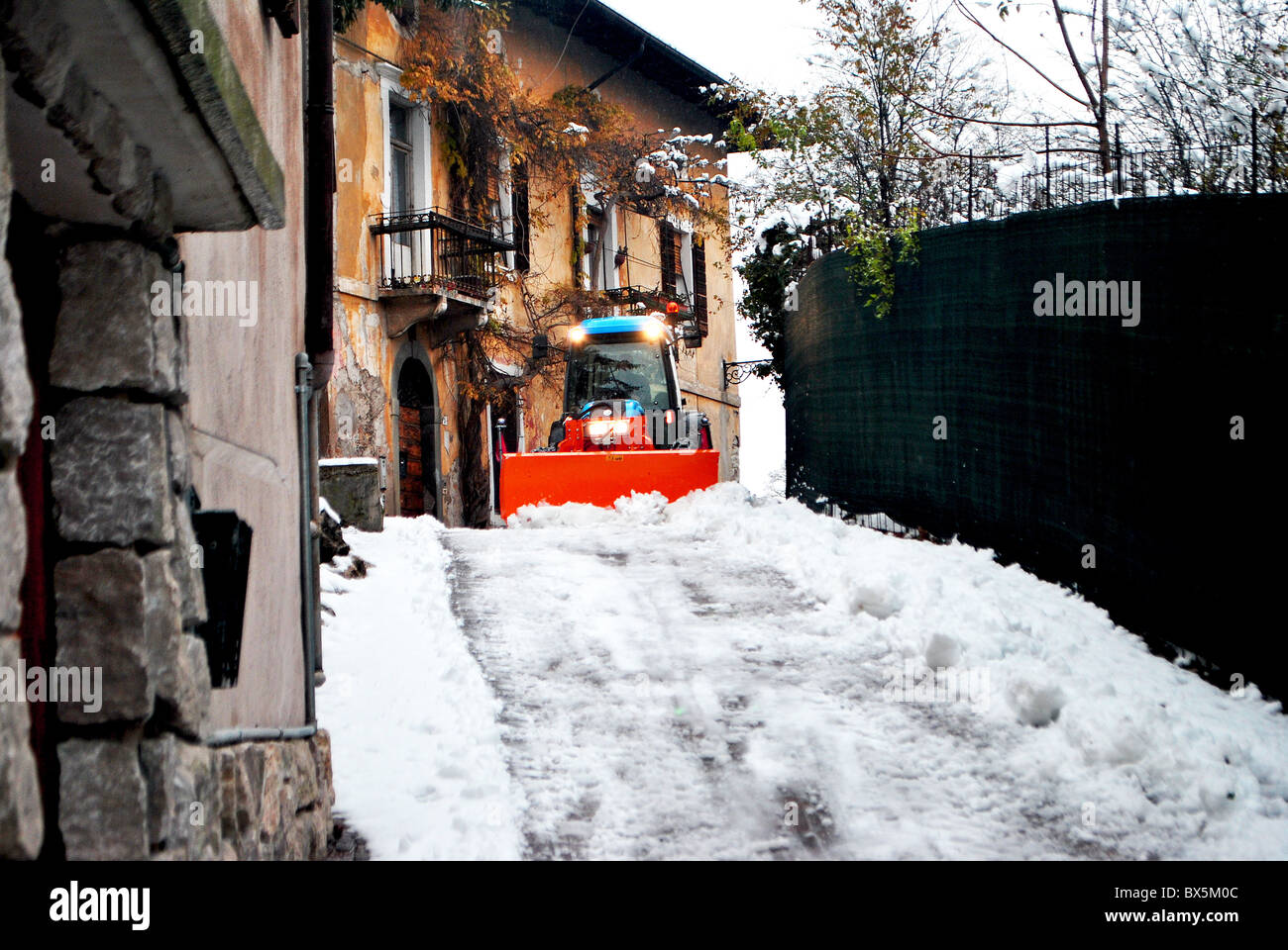 Tractor cleaning snow in winter Stock Photo - Alamy