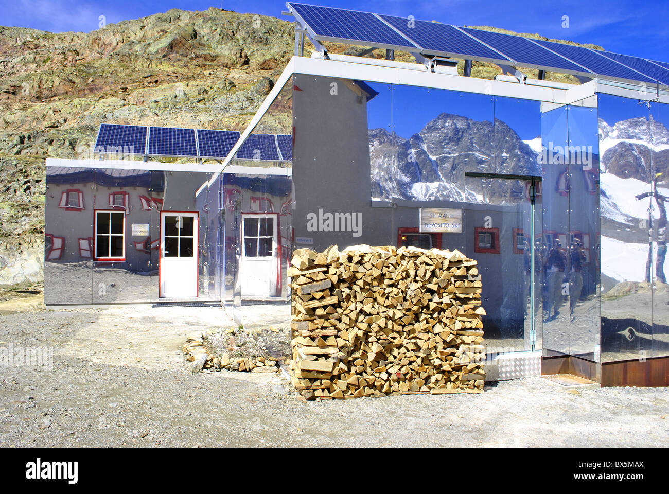 steel building reflecting the mountains of the Dolomites Stock Photo ...