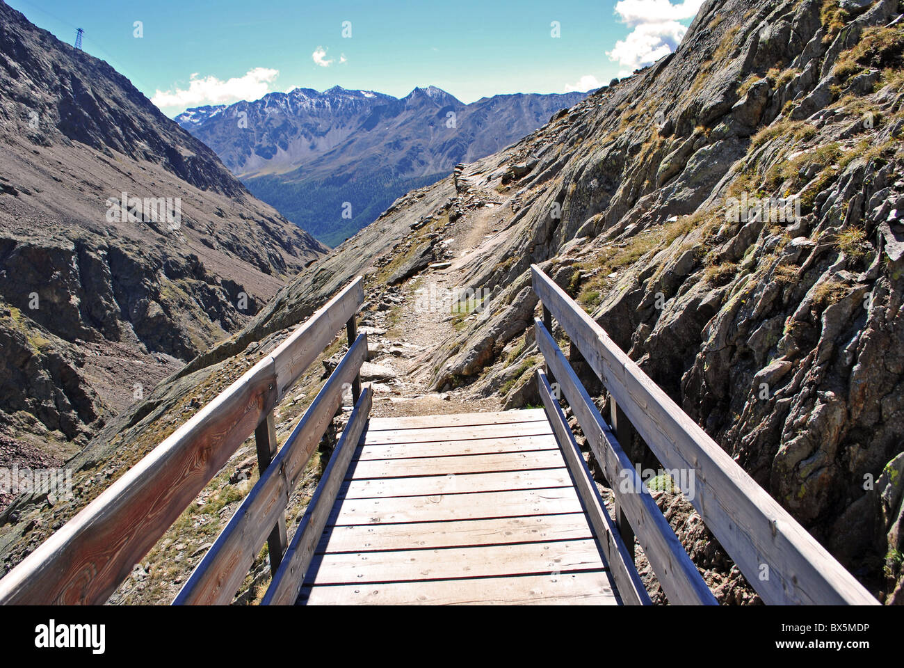 mountain path with wooden bridge Stock Photo - Alamy