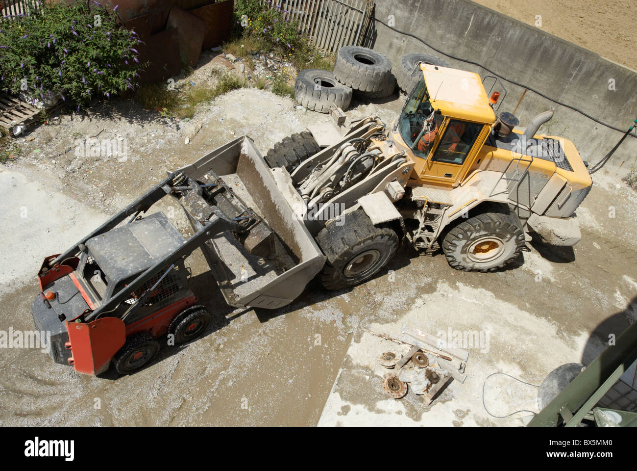Mini-dumper clearing sludge away from a Glass recycling machine at Day ...