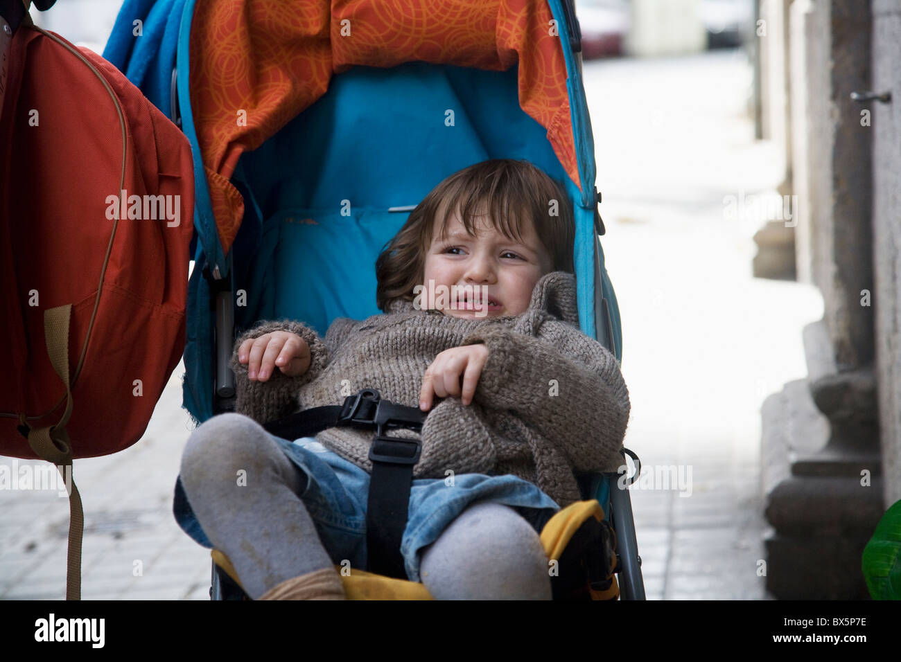 Tired 23 month boy crying in his pushchair Stock Photo - Alamy