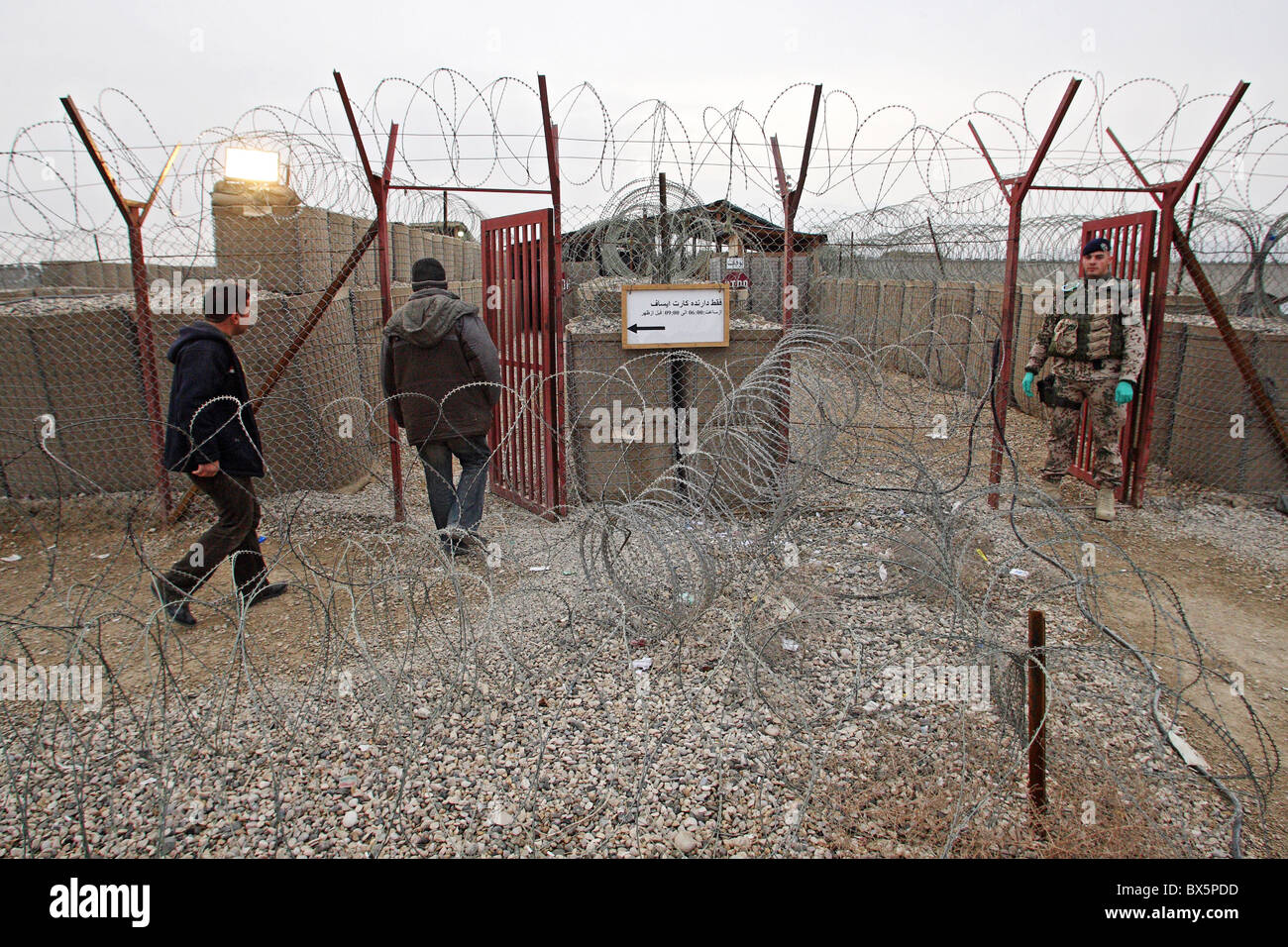 An ISAF soldier in front of the entrance to Camp Marmal, Mazar-e Sharif ...