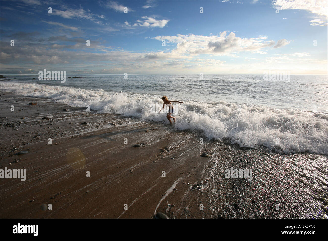 running from the tide Stock Photo - Alamy