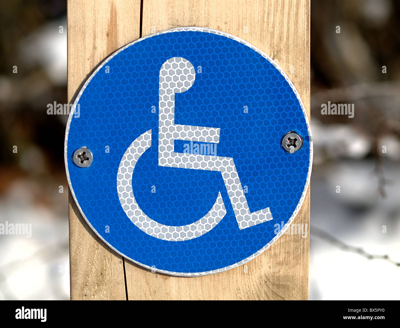 A reflective disabled parking sign on wooden post Stock Photo - Alamy