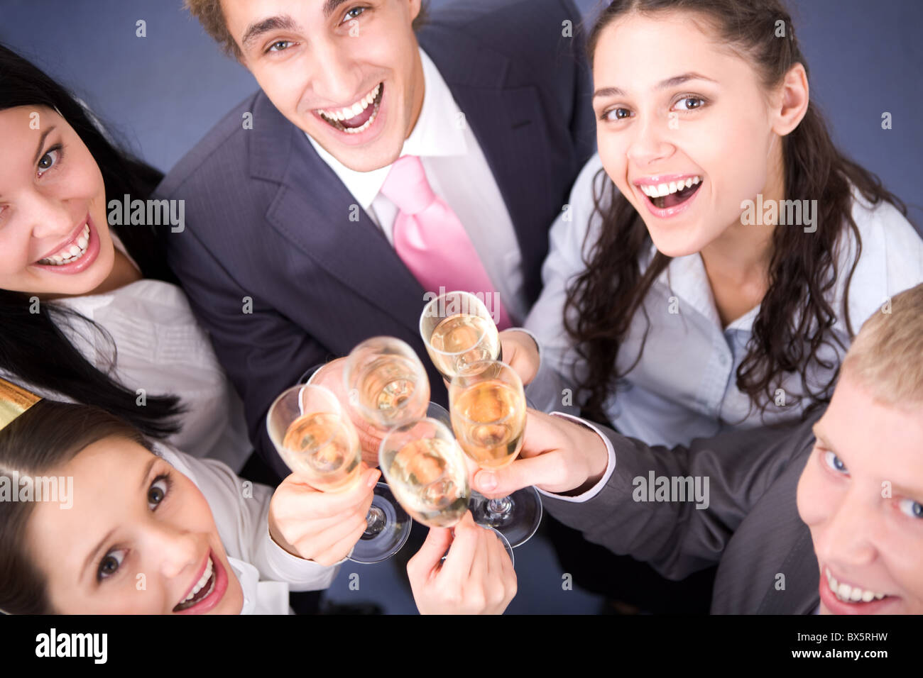 Photo of happy friends cheering up during corporate party Stock Photo ...