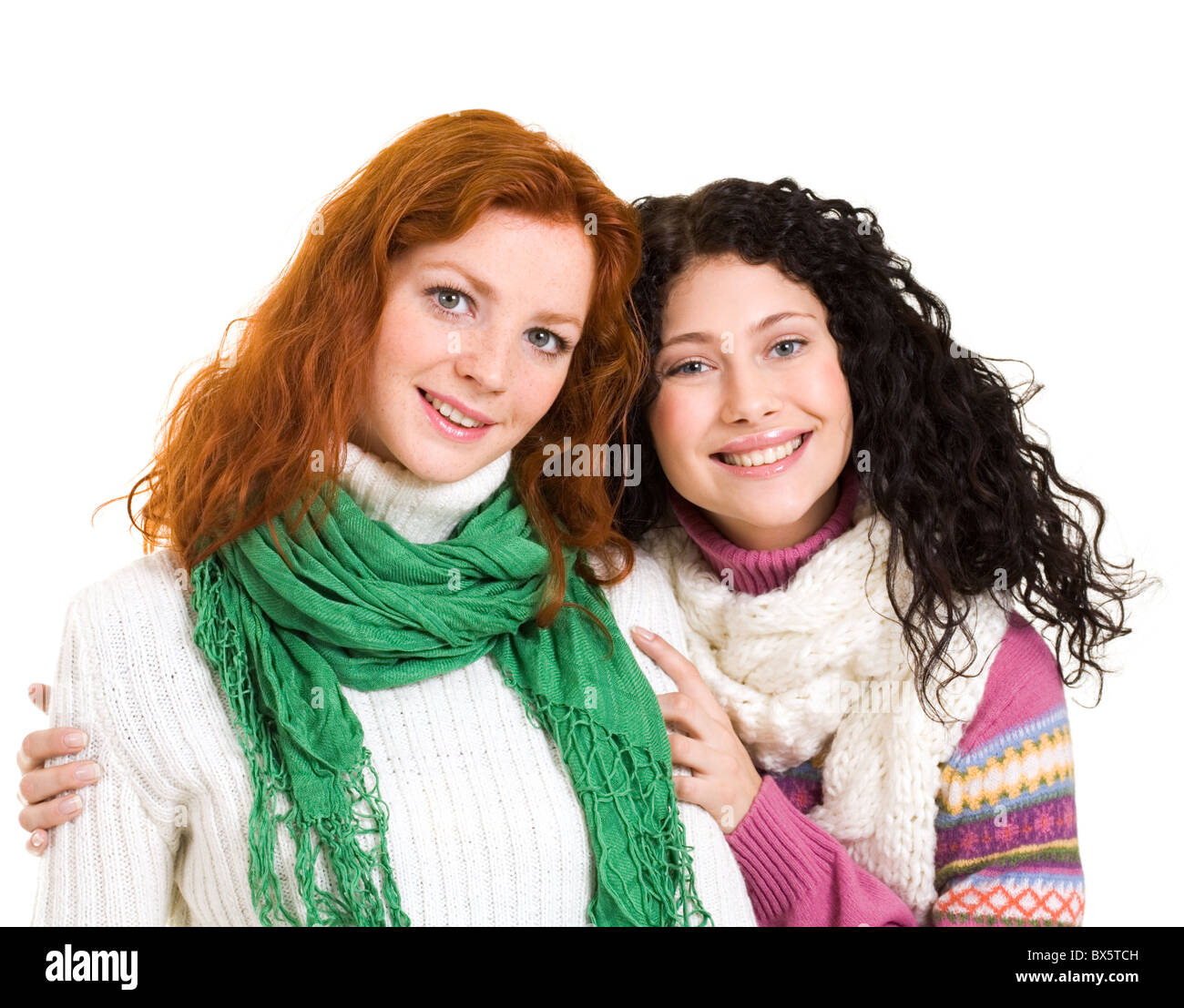 Portrait of pretty girls wearing sweaters and scarves and looking at ...