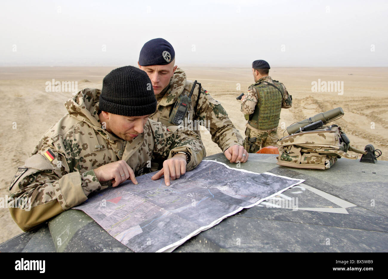 Bundeswehr soldiers of the ISAF checking coordinates on a map during ...