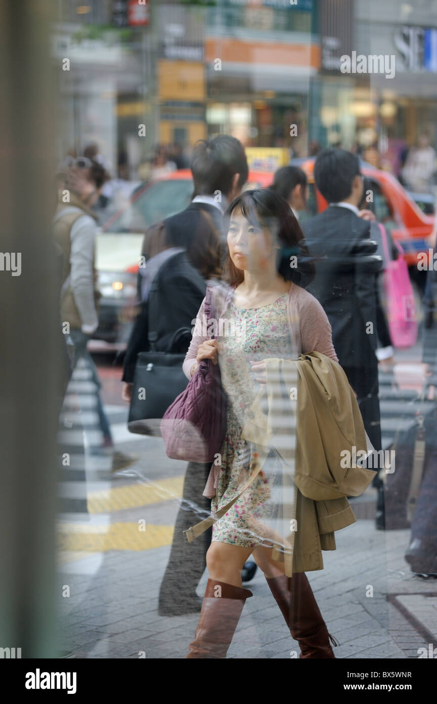 Young Japanese woman passing by seen through a window, Shibuya, Tokyo ...