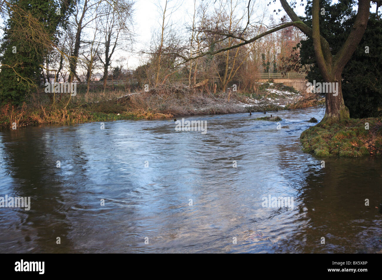 The River Yare in winter with reflections flowing by Earlham Park ...