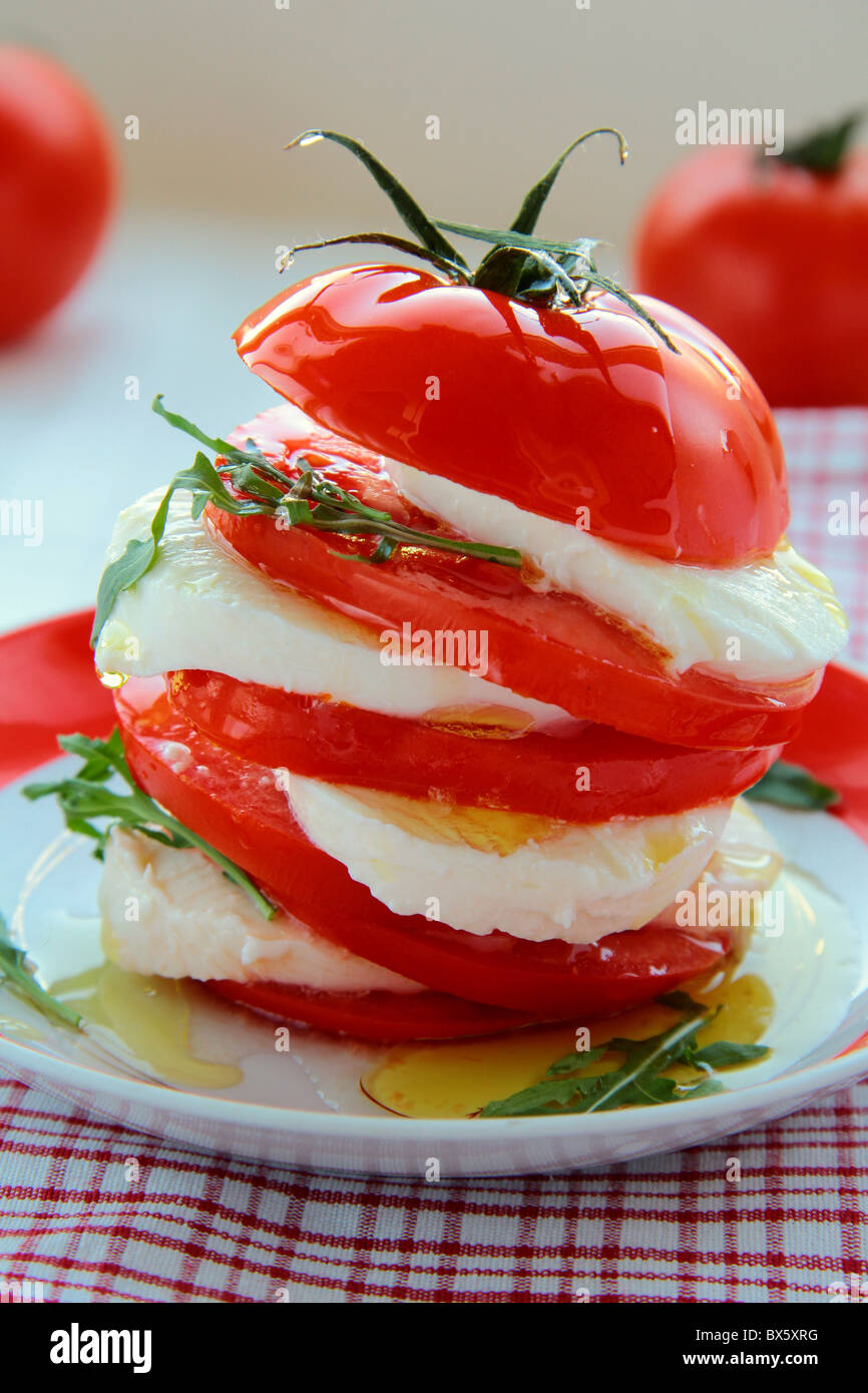 Caprese salad with arugula and olive oil on the plate Stock Photo - Alamy