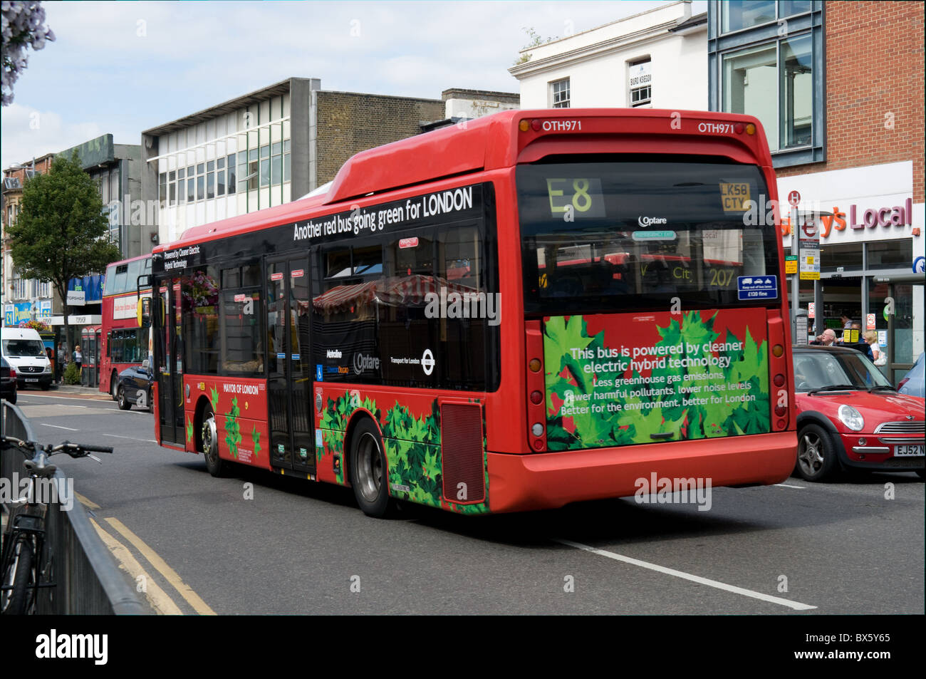A single deck hybrid bus passes through Ealing, west London. The bus is ...