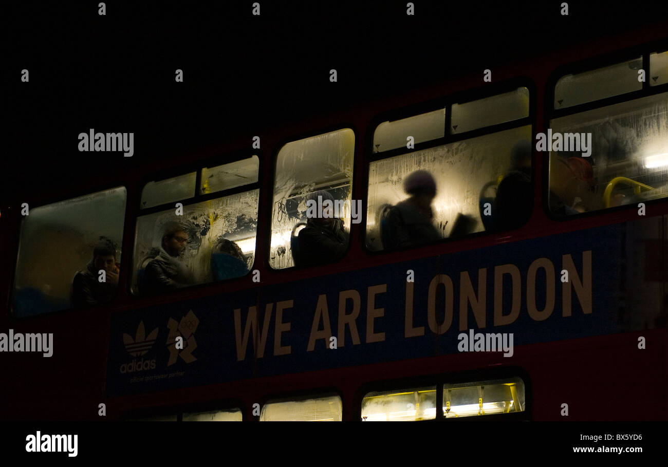 London Bus at Night. Evening commuters return home on a London Red Bus ...
