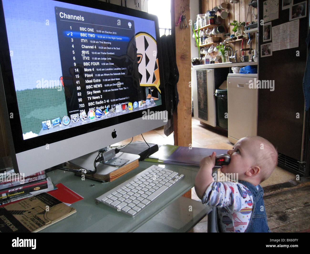 teething toddler playing with computer chewing on the mouse Stock Photo ...