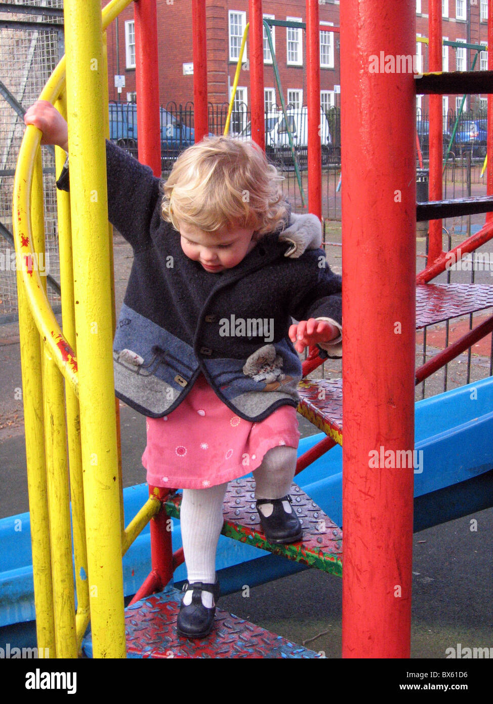 toddler climbing down a ladder on a playground slide Stock Photo - Alamy